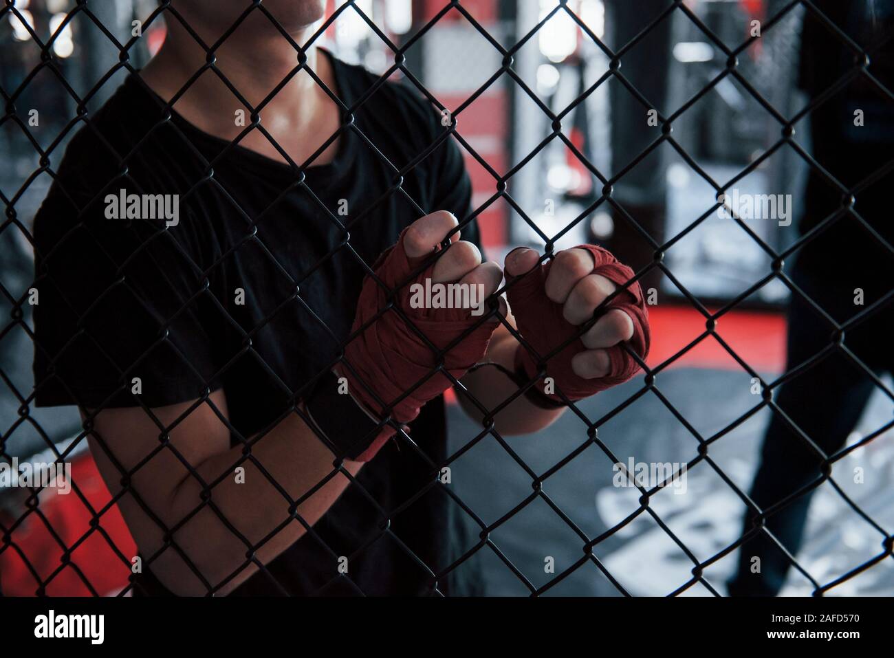 Taking a break. Sportsman at boxing ring have exercise. Leaning on the ...