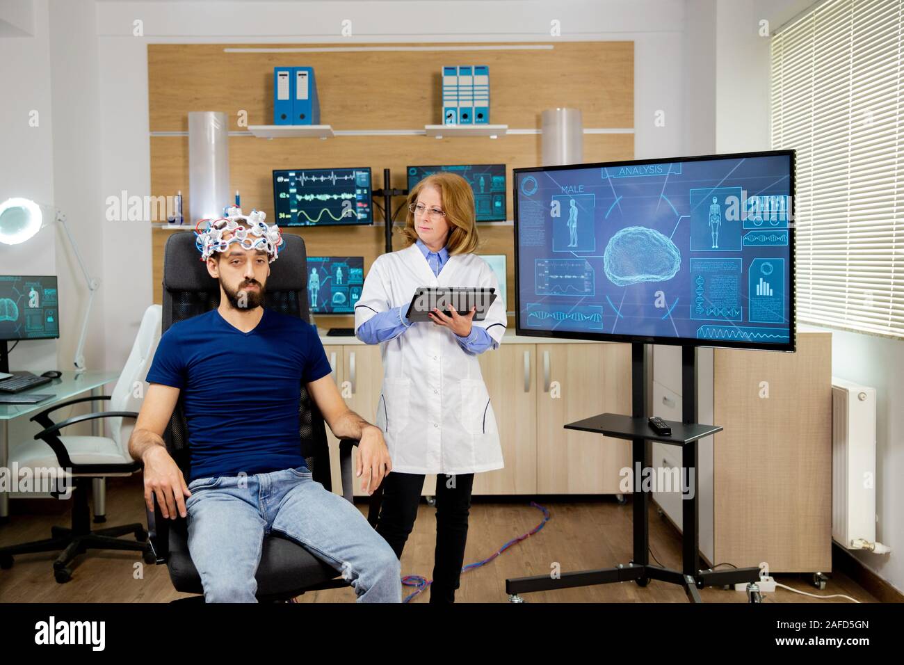 Doctor following a male patient during brain scan procedures. Brain ...