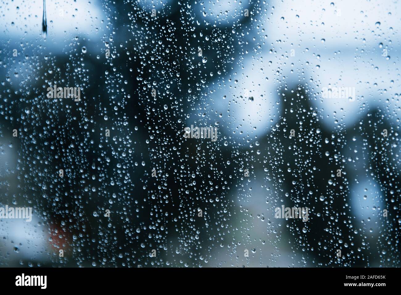 Waterdrops on the clean glass. Window and rainy day. Close up view ...