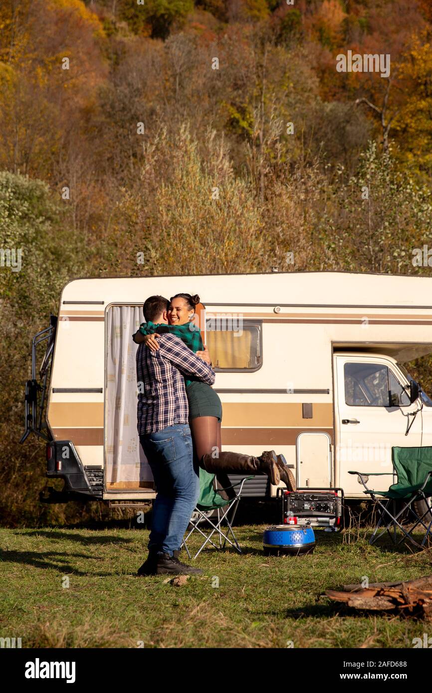 Cheerful couple having a moment of affection in front of their retro ...