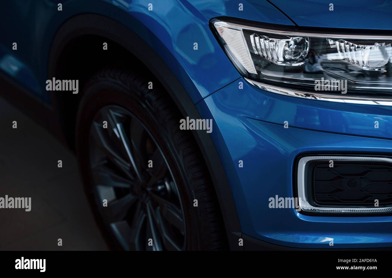 Front part of brand new modern blue car. Parked at showroom. Reflection ...