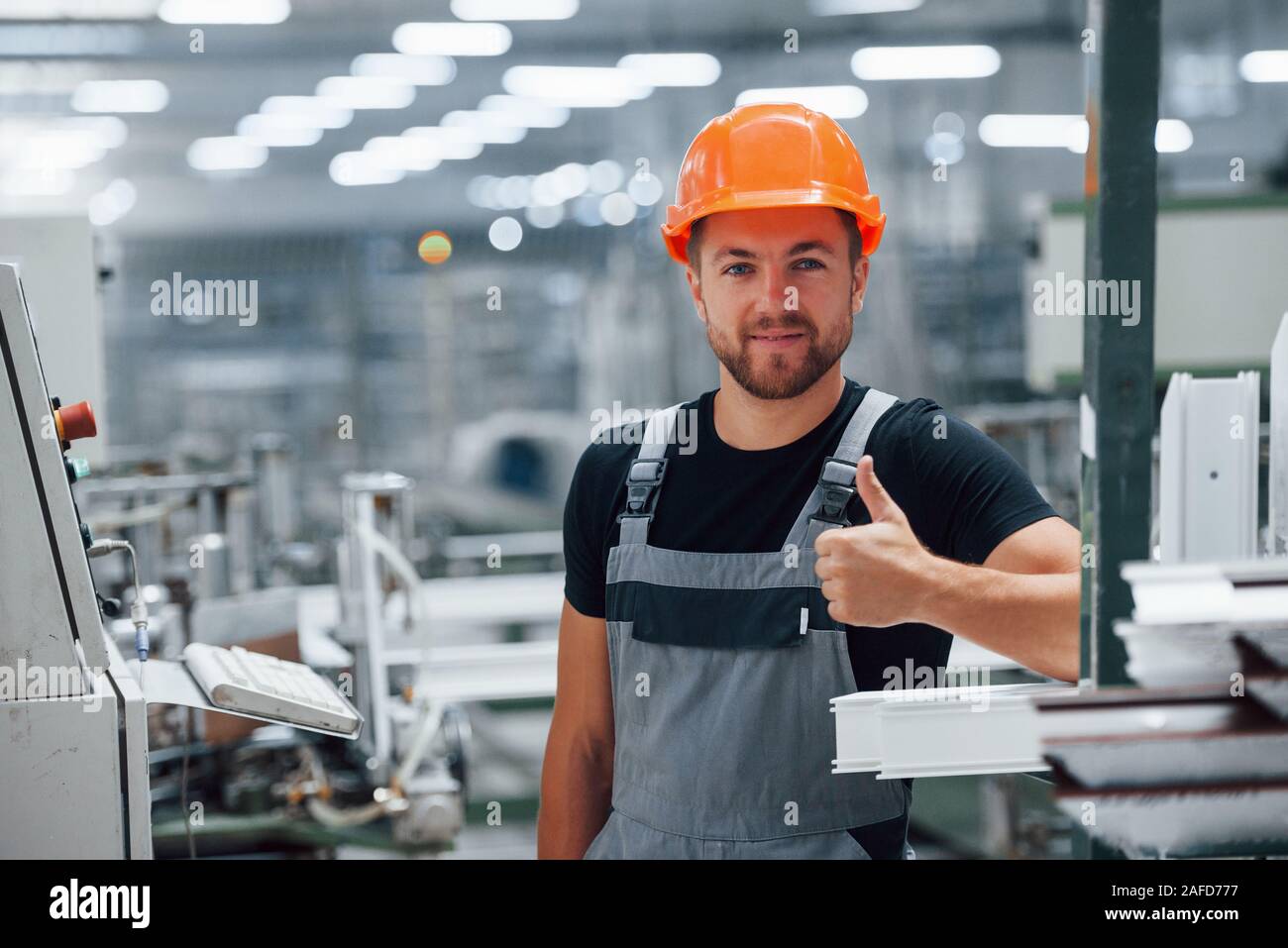 Shows thumb up. Well done. Everything is good. Industrial worker ...