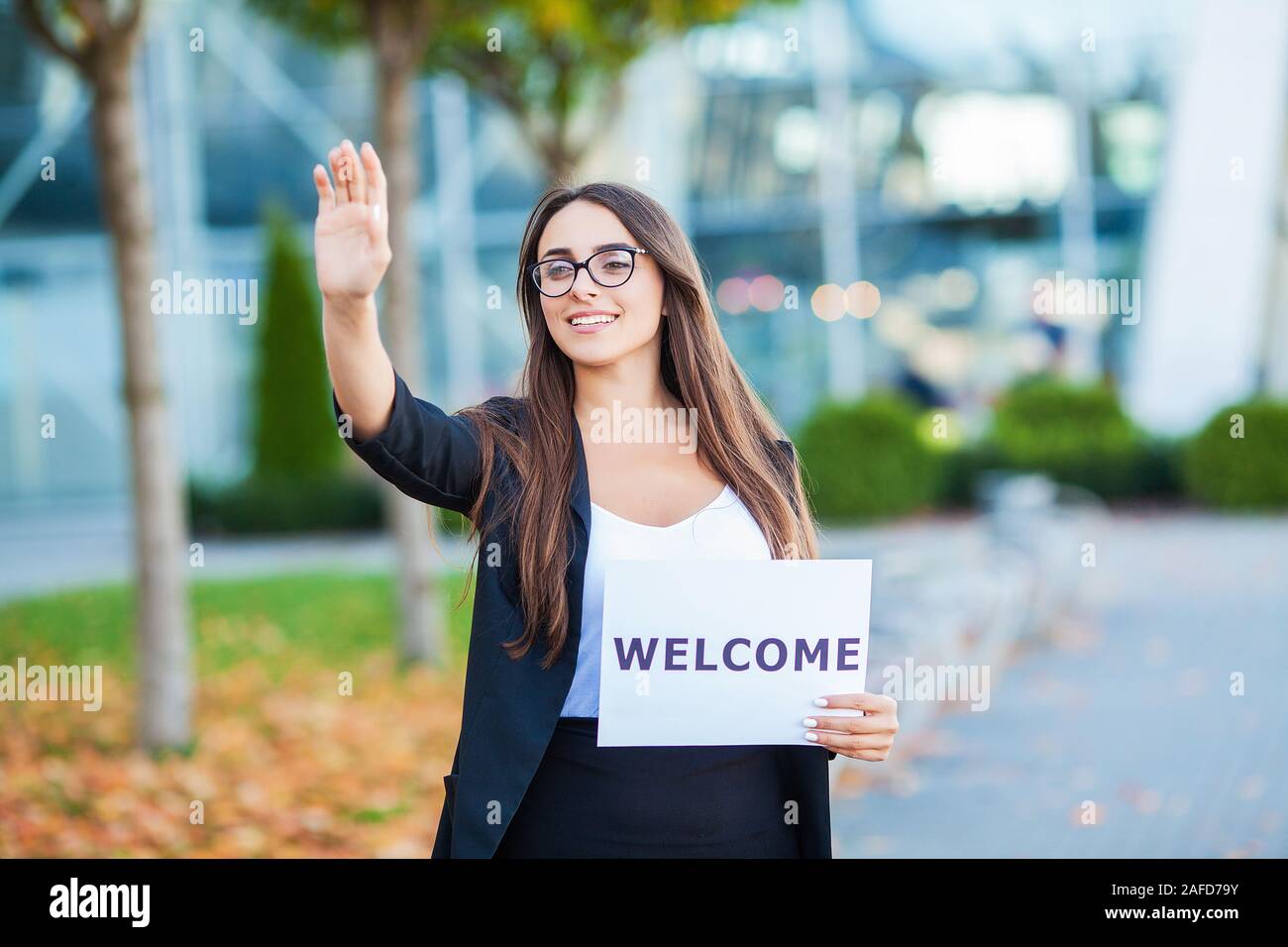 Women business with the poster with welcome message Stock Photo - Alamy