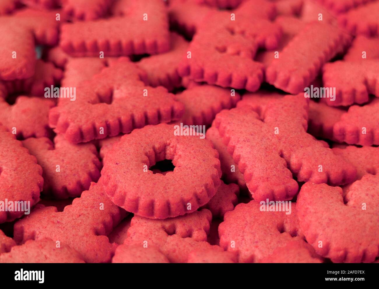 Closeup the letters OK on coral pink alphabet shaped cookies pile Stock ...