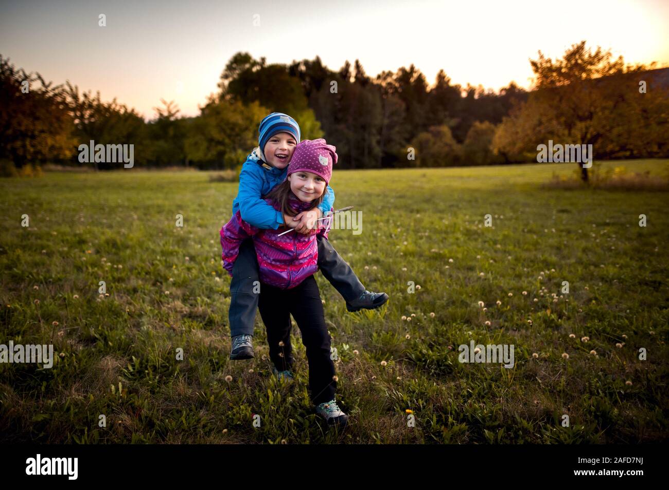 Sister carrying brother hi-res stock photography and images - Alamy