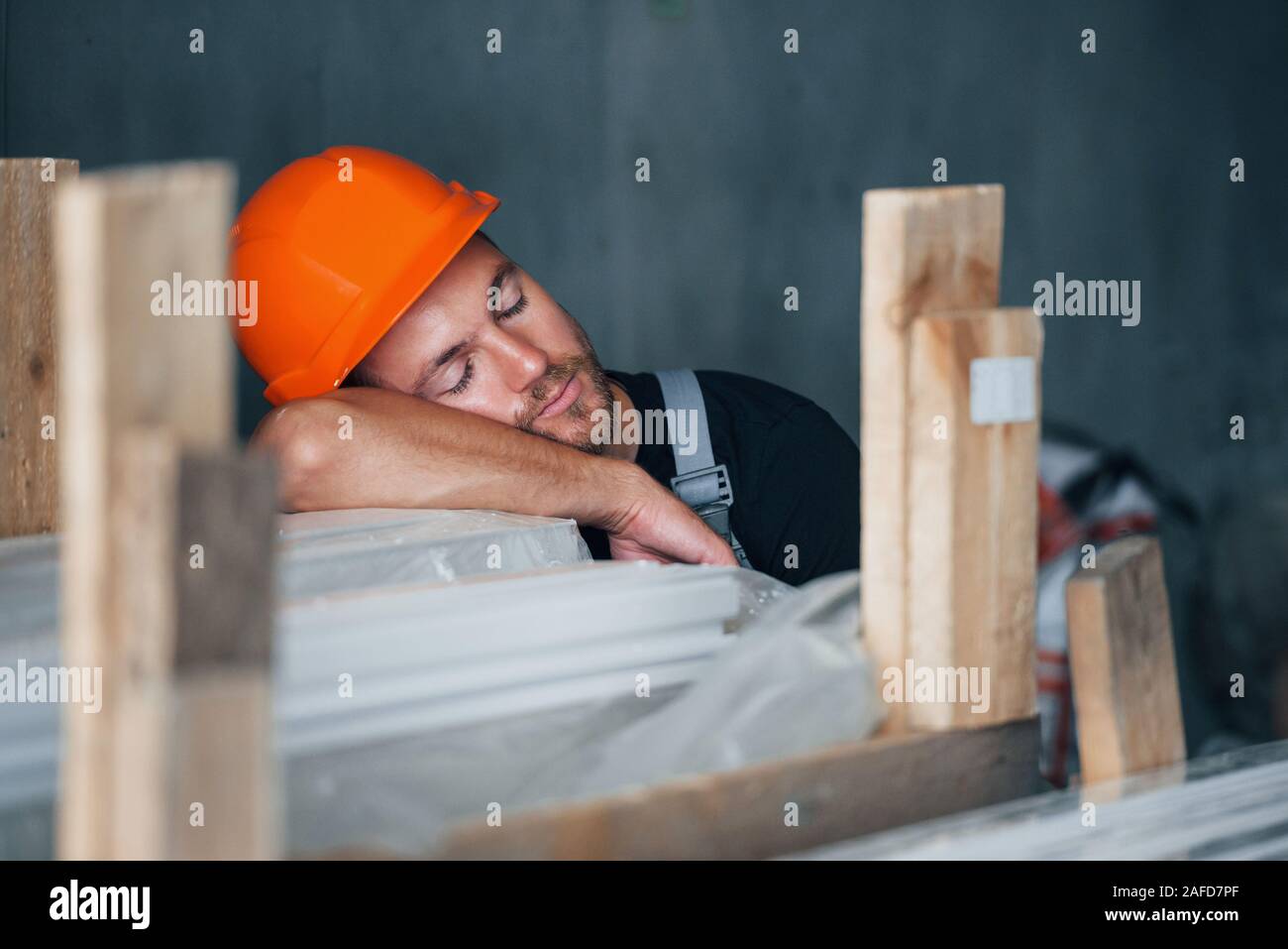 Sleeping on a job. Taking a break. Industrial worker indoors in factory ...