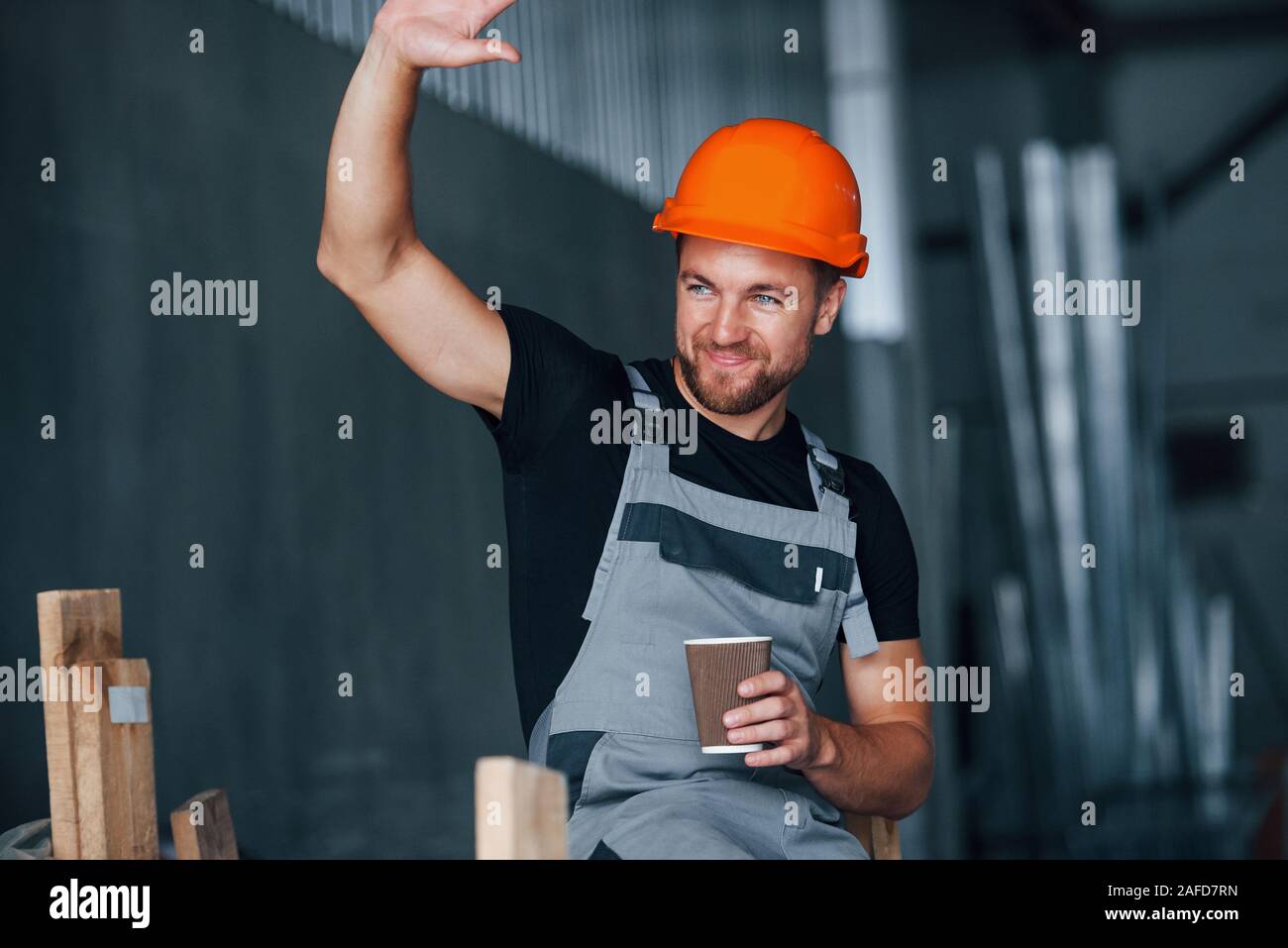 Hello gesture. With cup of drink. Lunch break. Cheerful industrial ...