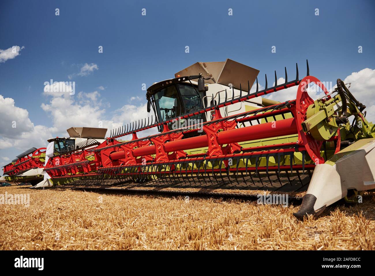 Large combine harvesters parked in agriculturic field at summertime ...
