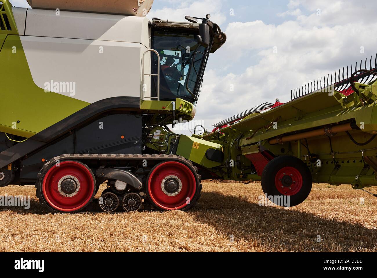 Large combine harvesters working in agriculturic field at summertime ...