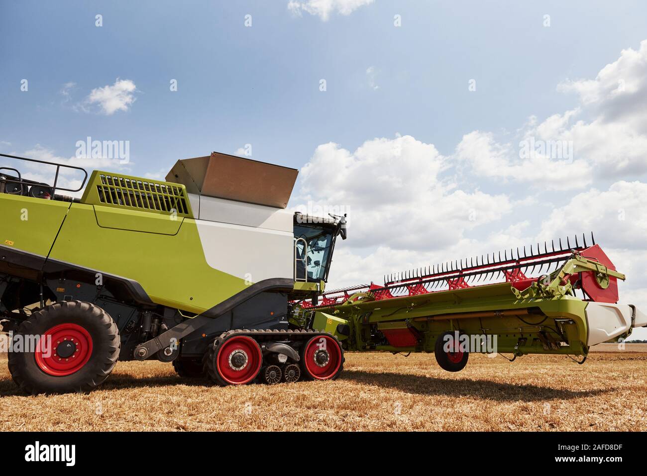 Large combine harvesters working in agriculturic field at summertime ...