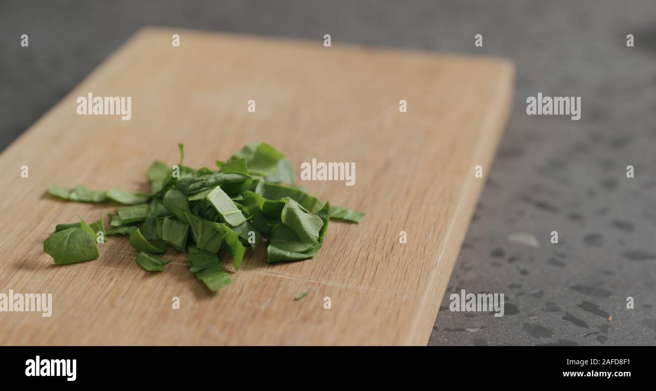 chopped fresh spinach leaves on oak cutting board, wide photo Stock ...