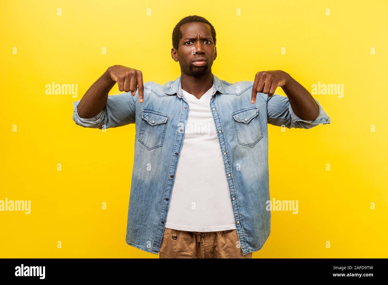 Here and right now. Portrait of bossy man in denim shirt with rolled up ...