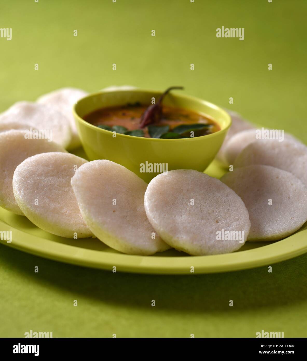 Idli with Sambar in bowl on green background, Indian Dish : south ...