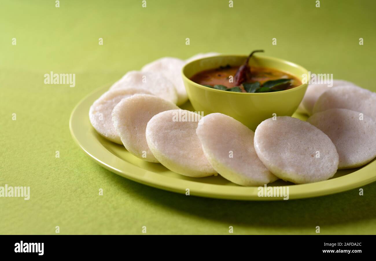 Idli with Sambar in bowl on green background, Indian Dish : south ...