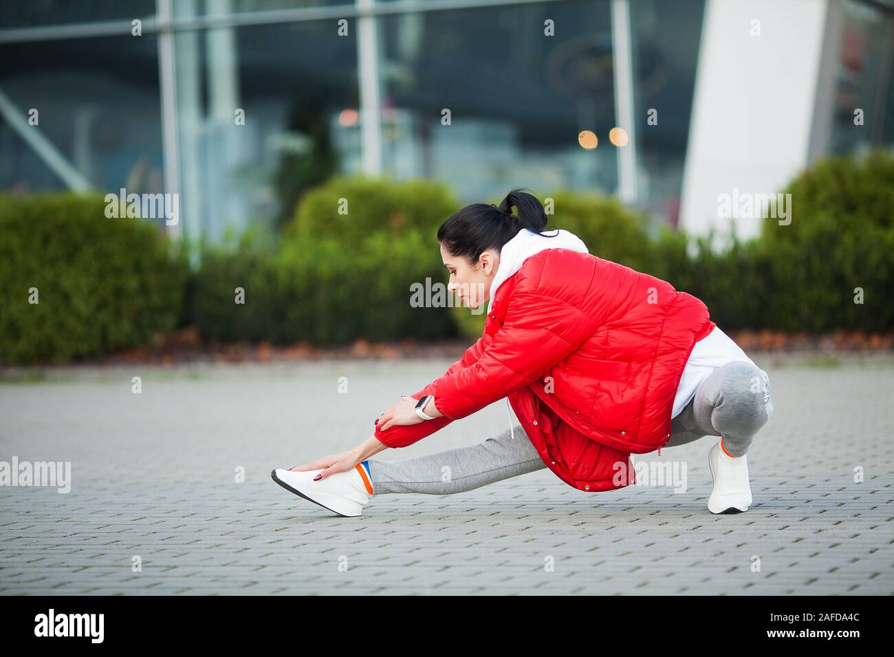 Woman Stretching Body, Doing Exercises On Street Stock Photo - Alamy