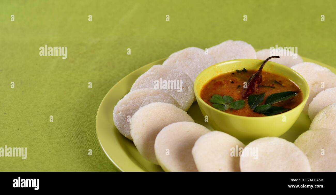 Idli with Sambar in bowl on green background, Indian Dish : south ...