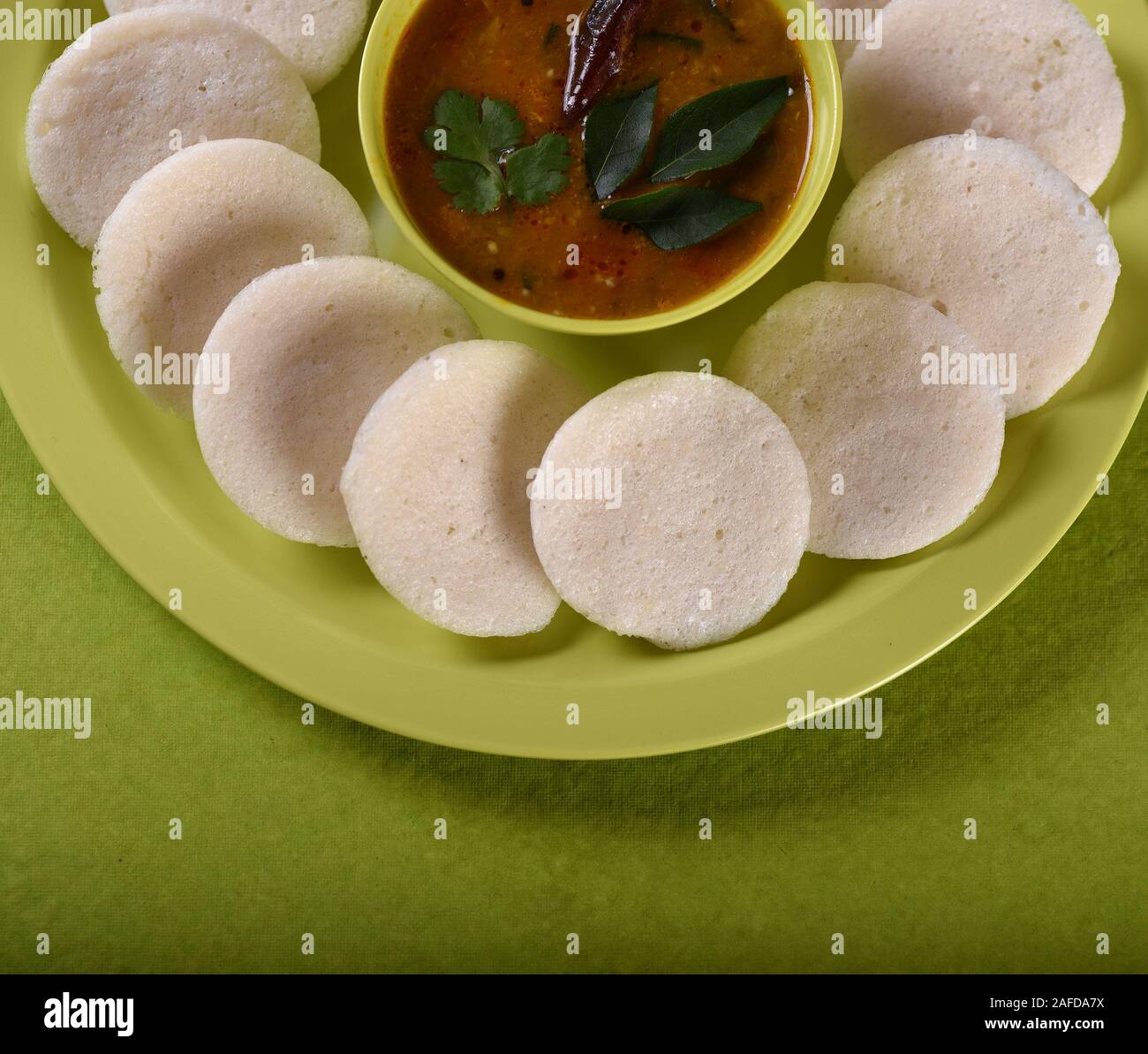Idli with Sambar in bowl on green background, Indian Dish : south ...