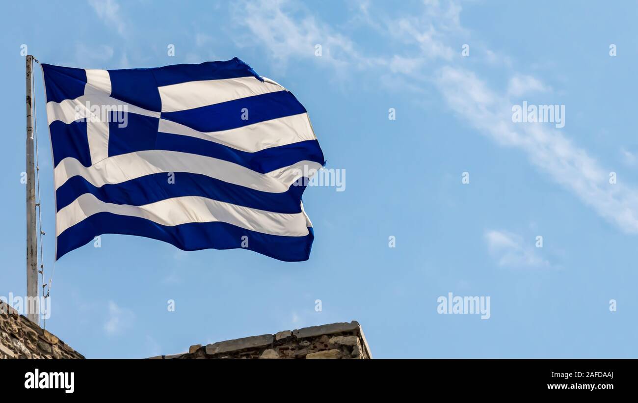 Greek national flag waving on blue sky background. Hellenic Republic ...