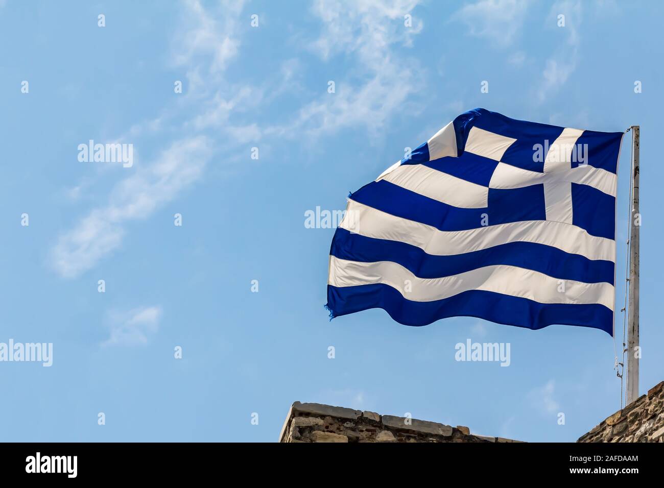 Greek national flag waving on blue sky background. Hellenic Republic ...