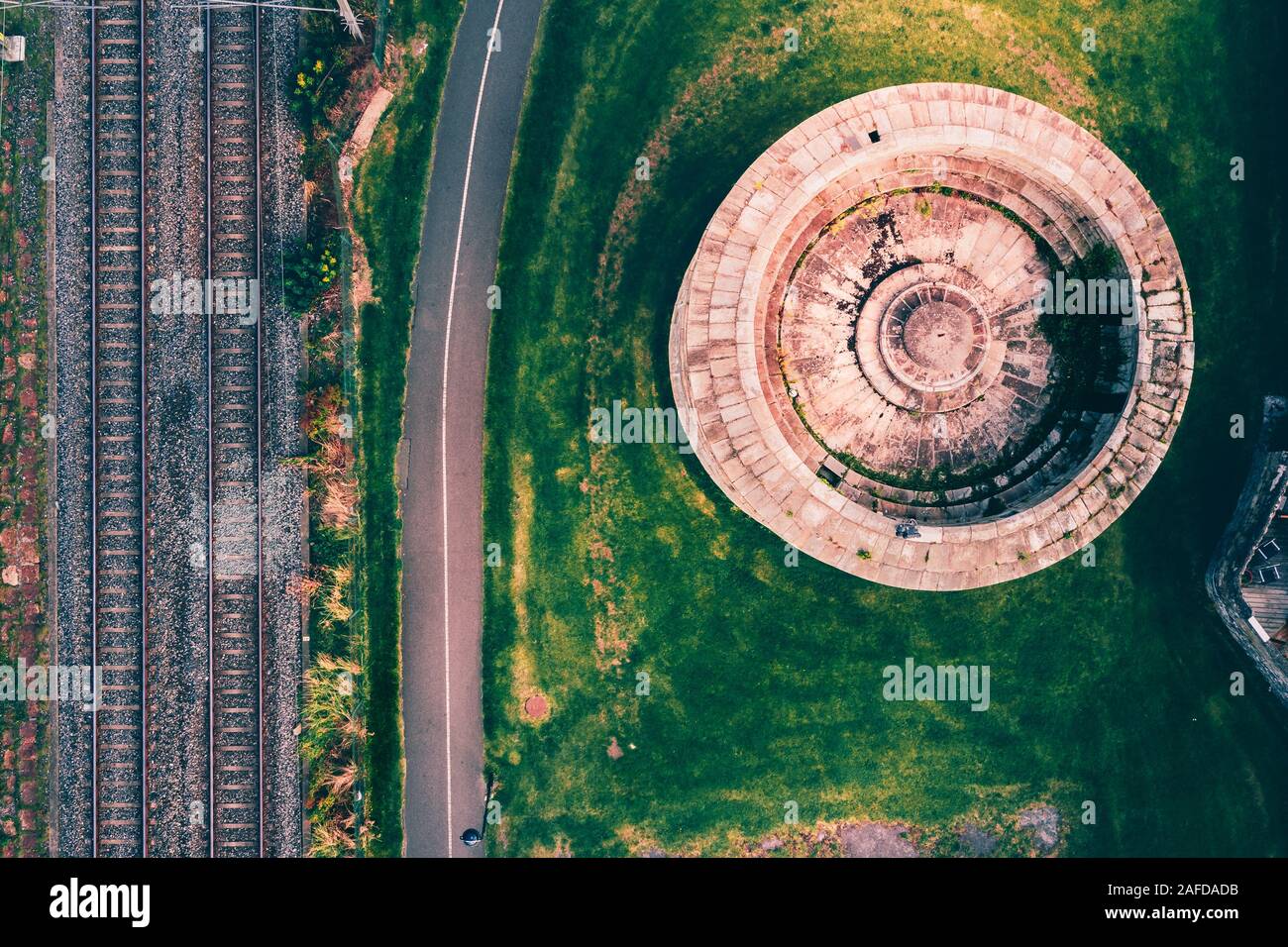 Top-down view Irish small tower and train rails on the coast of Dublin ...