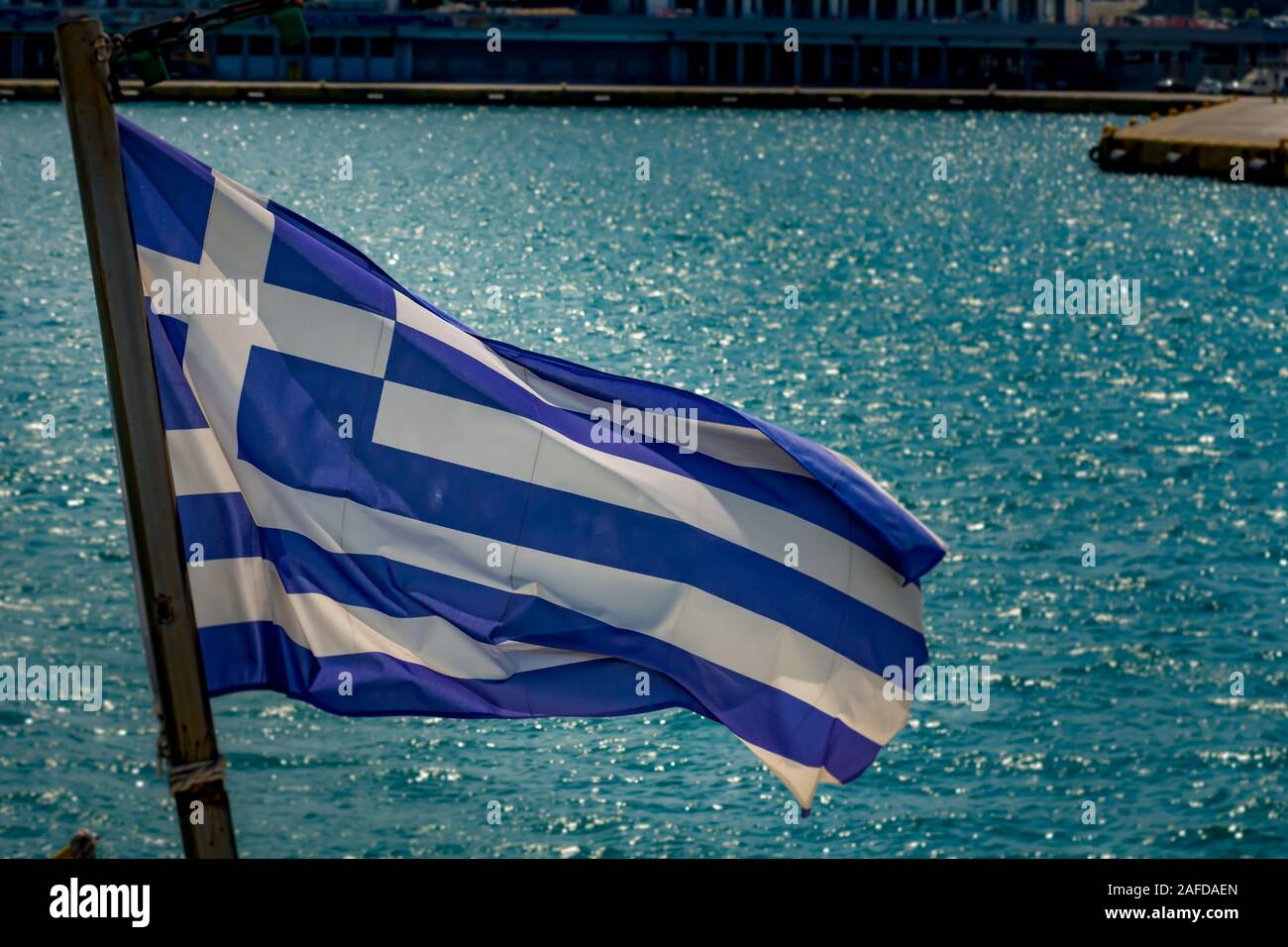 Greek national flag waving on blue sky background. Hellenic Republic ...