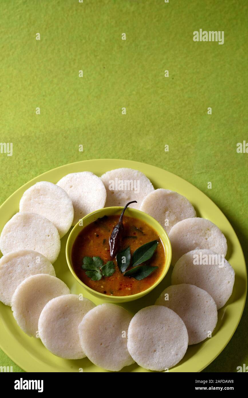Idli with Sambar in bowl on green background, Indian Dish : south ...