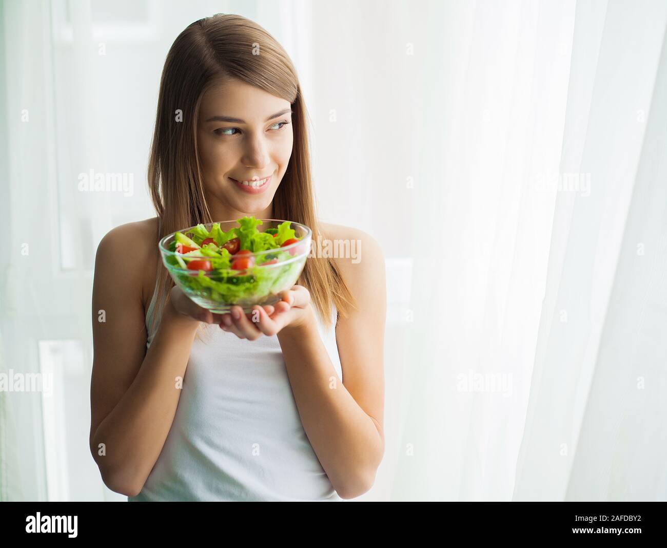 Diet and health.Young woman eating healthy food after workout Stock ...