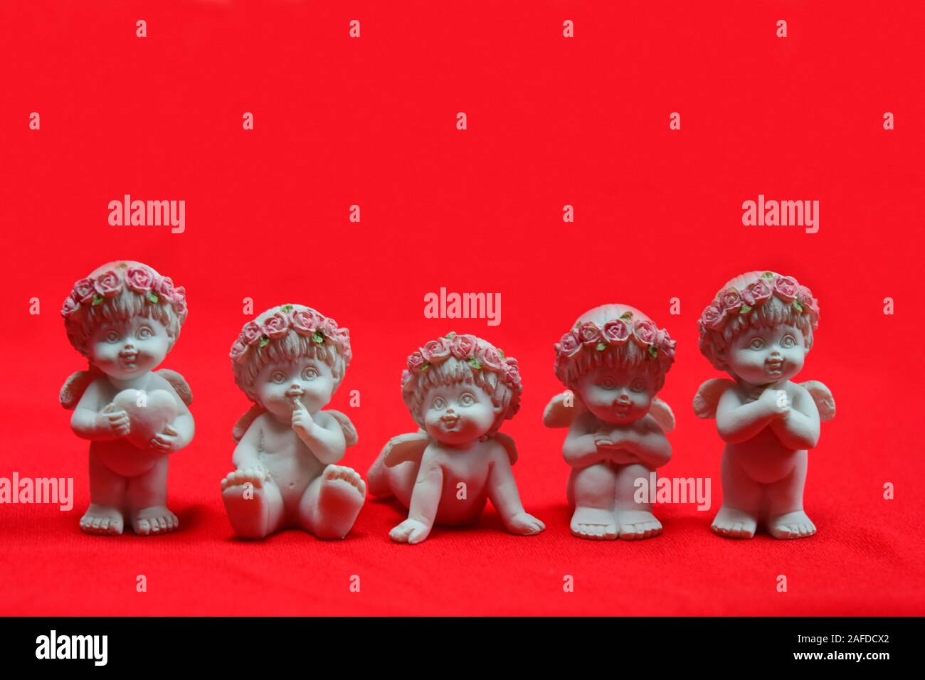 Little cupid or small angel together on red background, good feeling ...