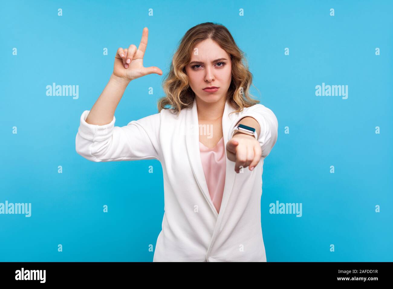 You are loser. Portrait of irritated woman with wavy hair in white ...