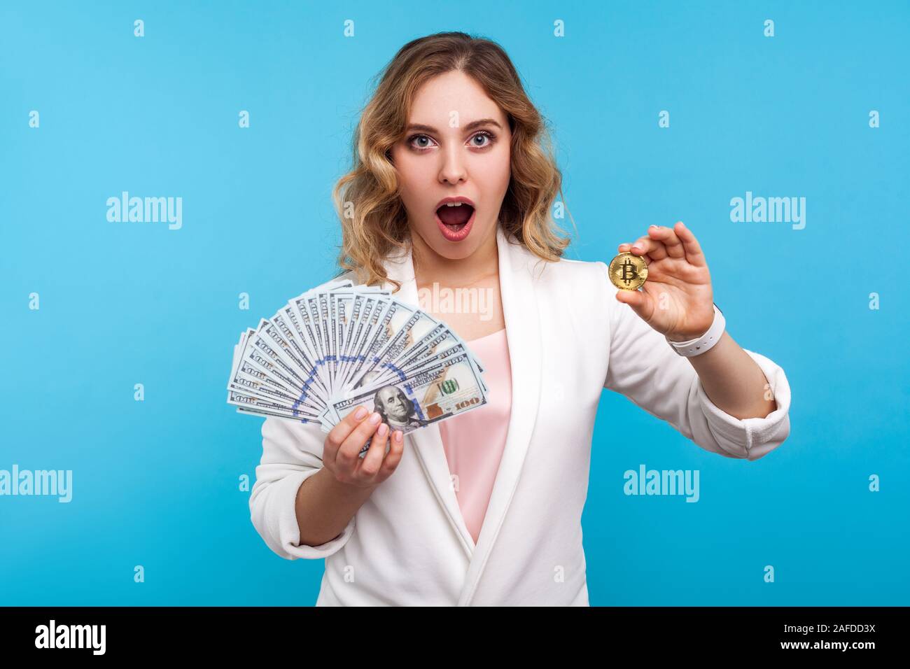 Cryptocurrency. Portrait of surprised charming woman with wavy hair in ...