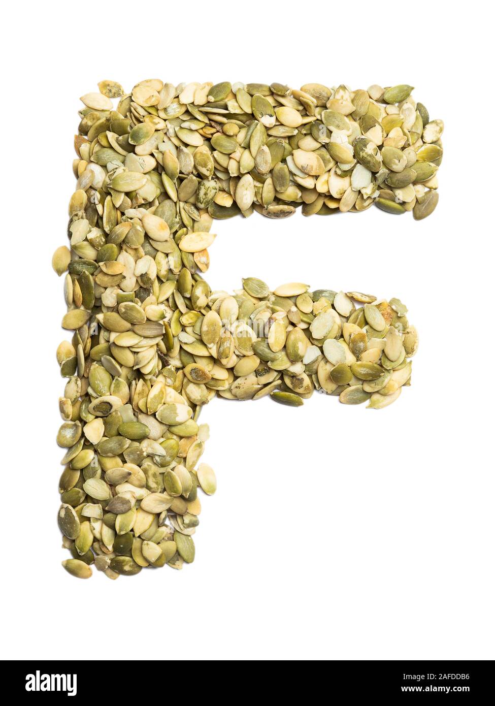 Letter F of the English alphabet from pumpkin seeds on a white isolated ...
