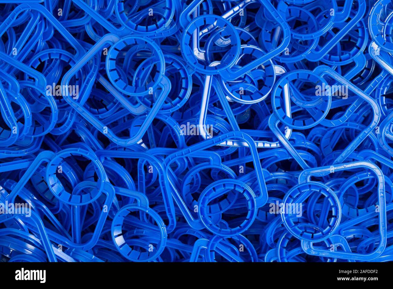 Background of new blue plastic handles for easy carrying of plastic ...