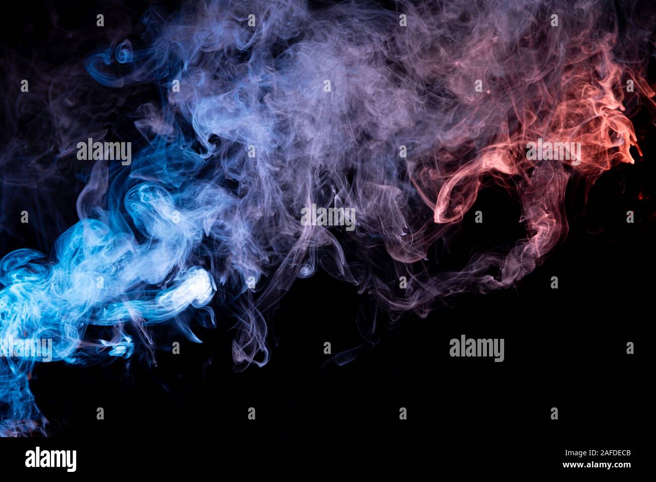 Abstract art blue and red colored smoke on black isolated background ...