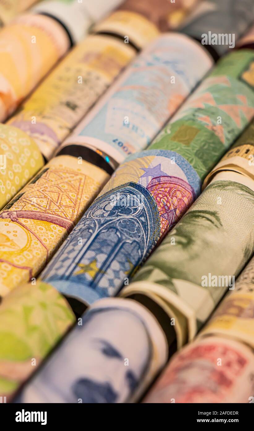Different colourful banknotes from various countries on rolls to be ...