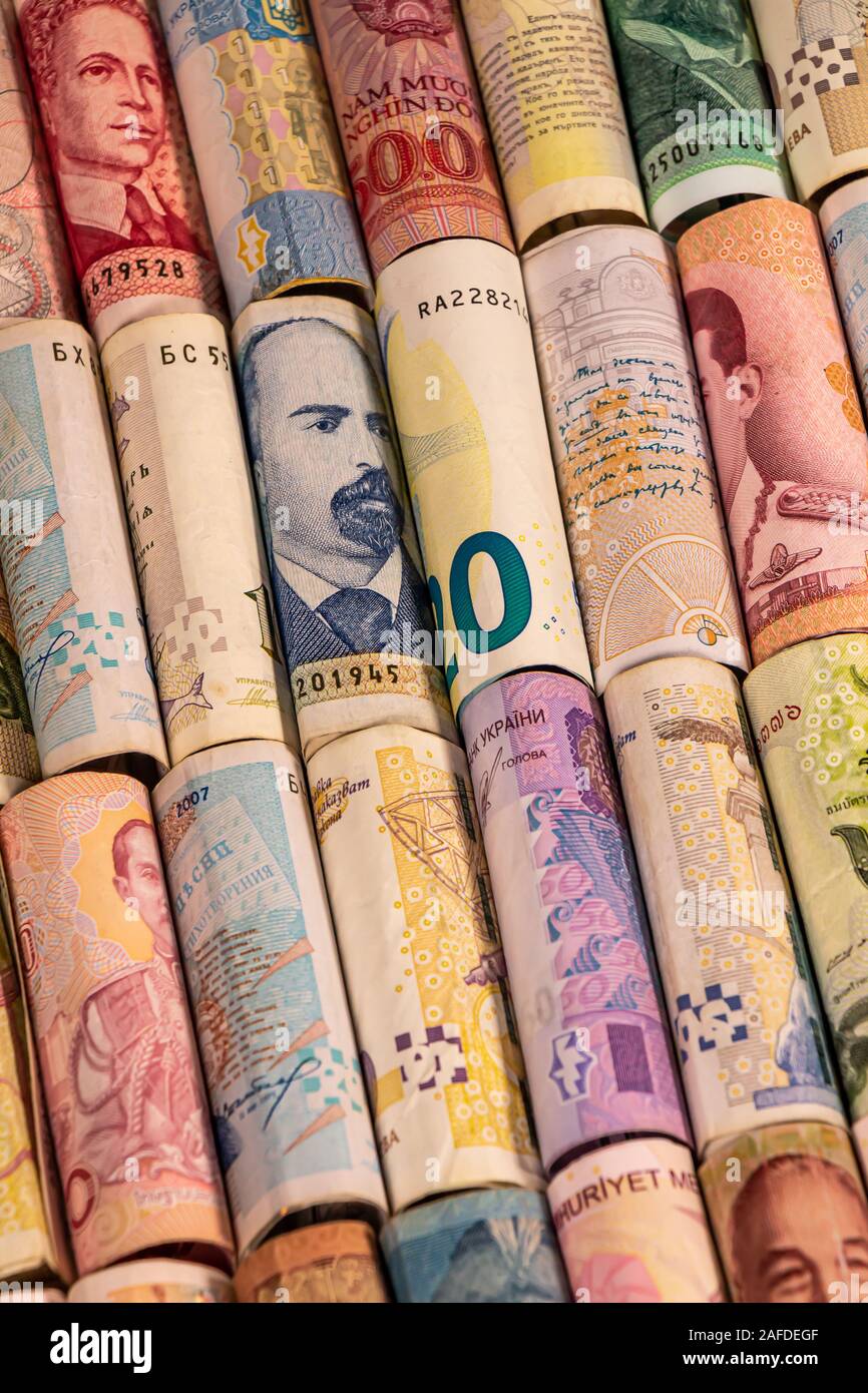 Different colourful banknotes from various countries on rolls to be ...