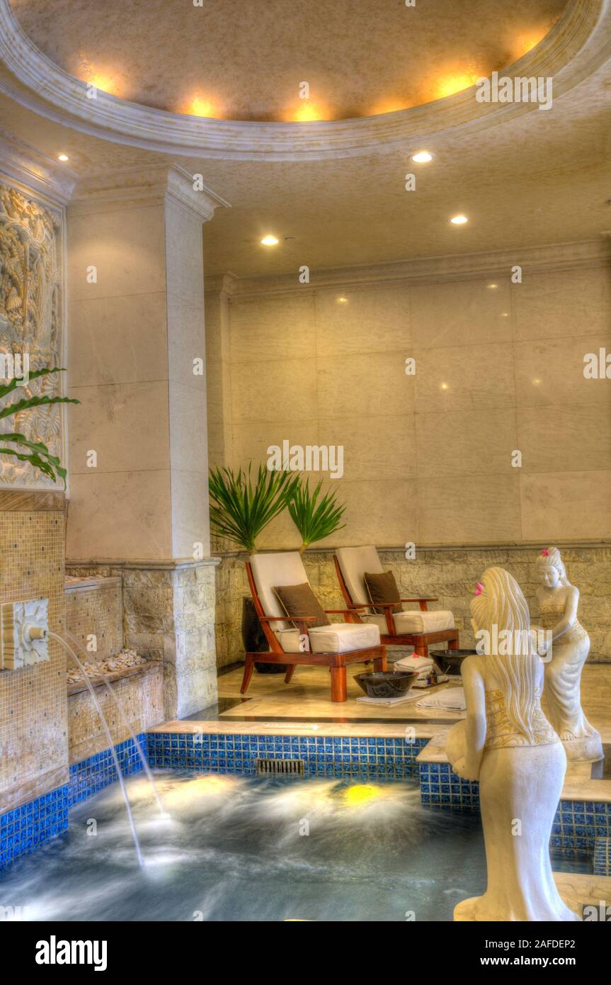 indoor spa with plunge pool and fountains and reclining lounge chairs ...