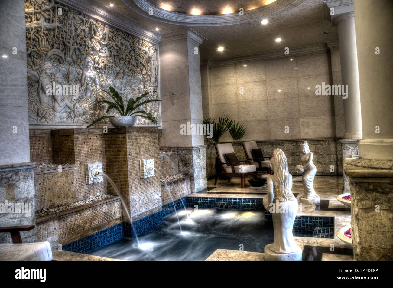 indoor spa with plunge pool and fountains and reclining lounge chairs ...