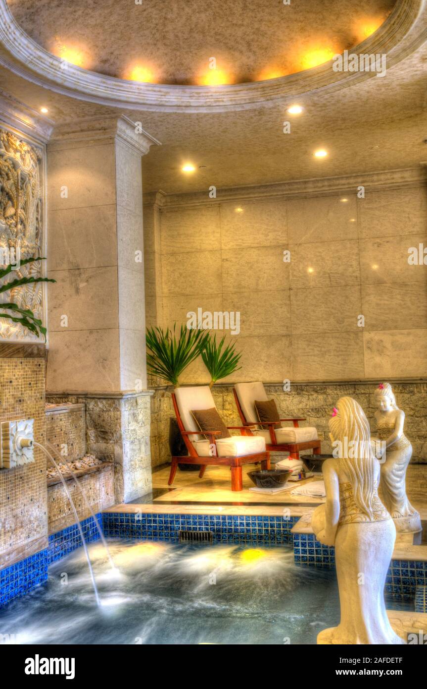indoor spa with plunge pool and fountains and reclining lounge chairs ...