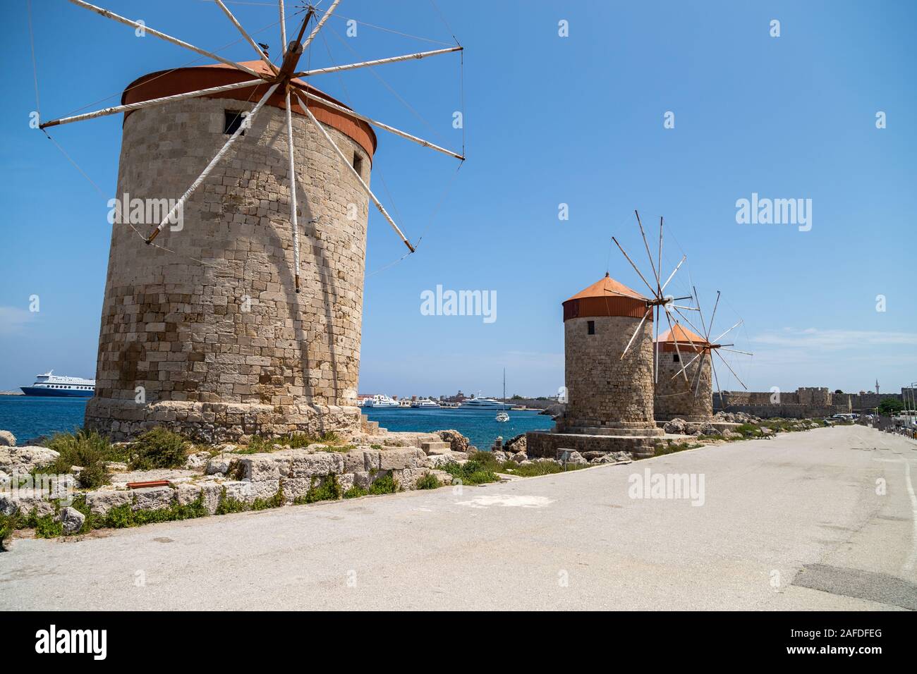 Old windmills at Mandraki harbour in Rhodes city on Rhodes island ...