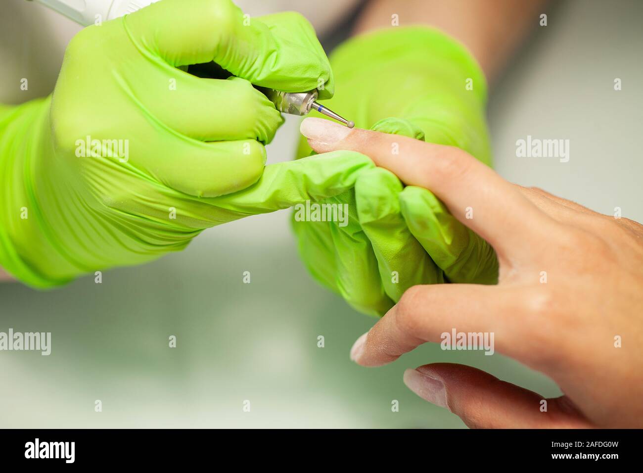 Manicure. Nails master doing manicure in beauty studio Stock Photo - Alamy