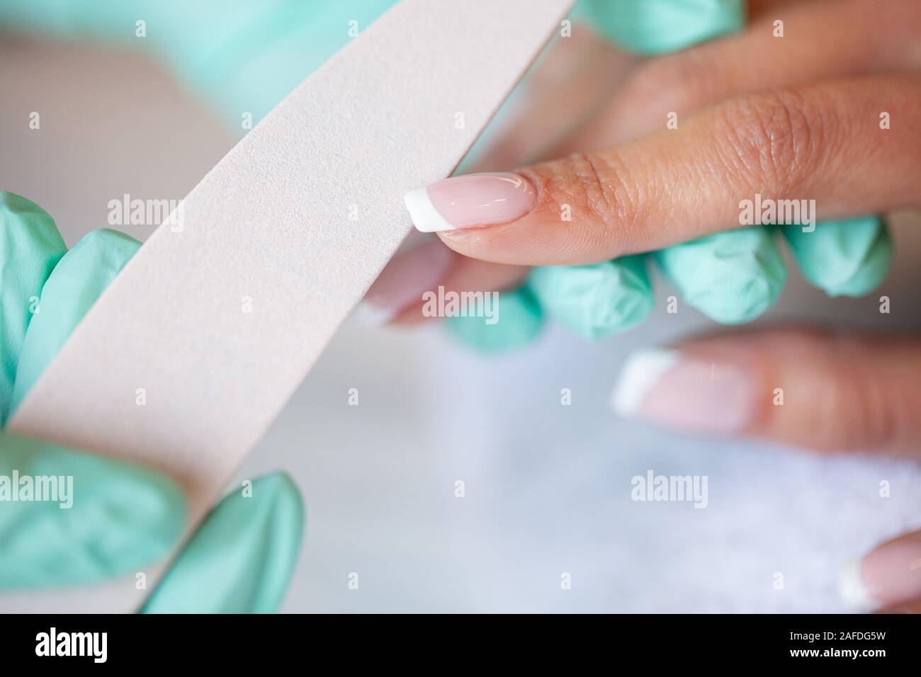 Manicure. Nails master doing manicure in beauty studio Stock Photo - Alamy