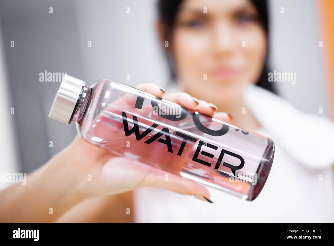 Fitness young woman drinking water in the gym Stock Photo - Alamy