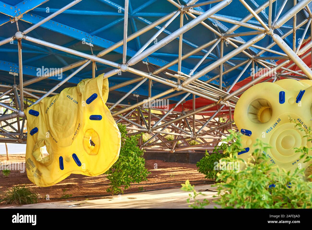 Damaged yellow inflatable float in water park Stock Photo - Alamy