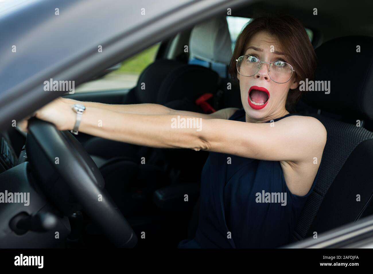 Beutiful woman in strict style of clothing gets out of the car for an ...