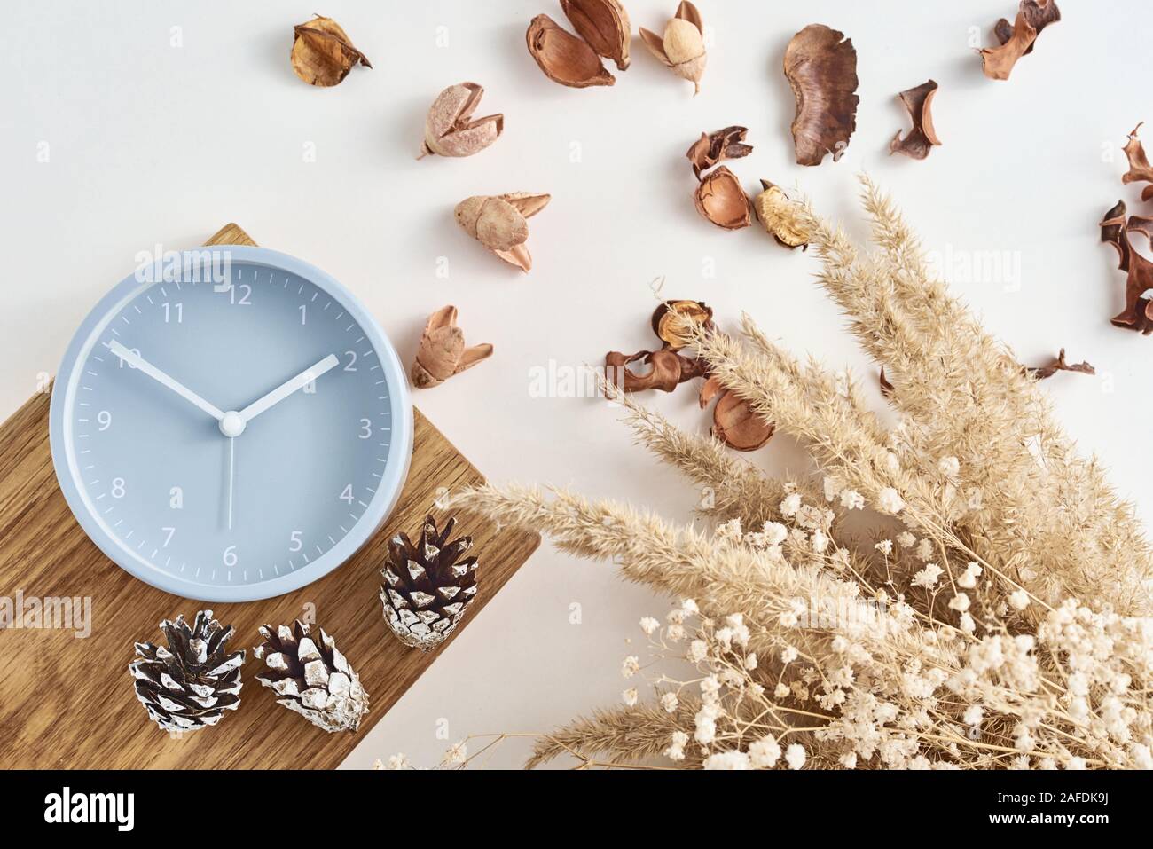 Alarm clock with decorations on white background, top view. Minimal ...