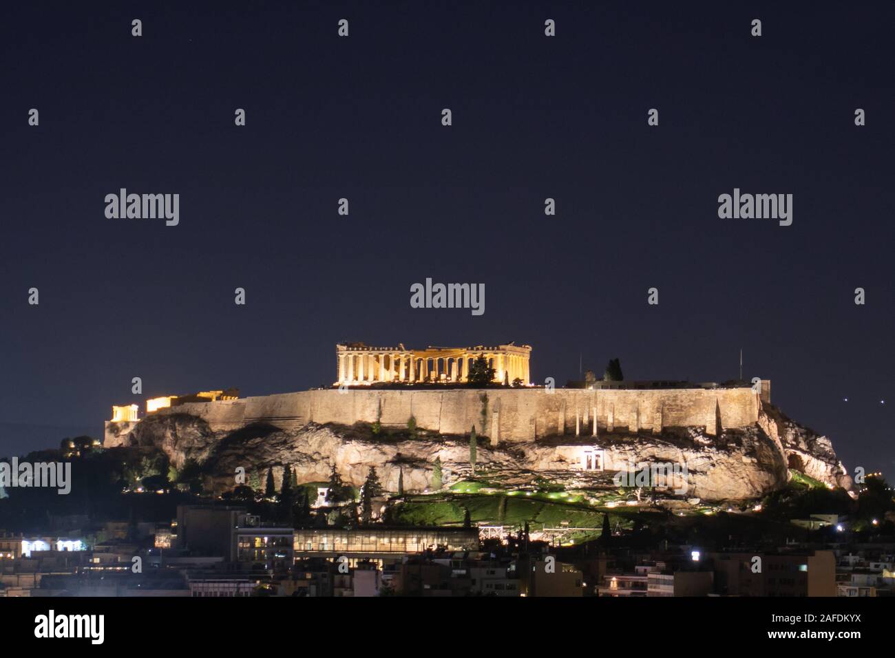 Night view of acropolis building on a hill with lights and beautiful ...