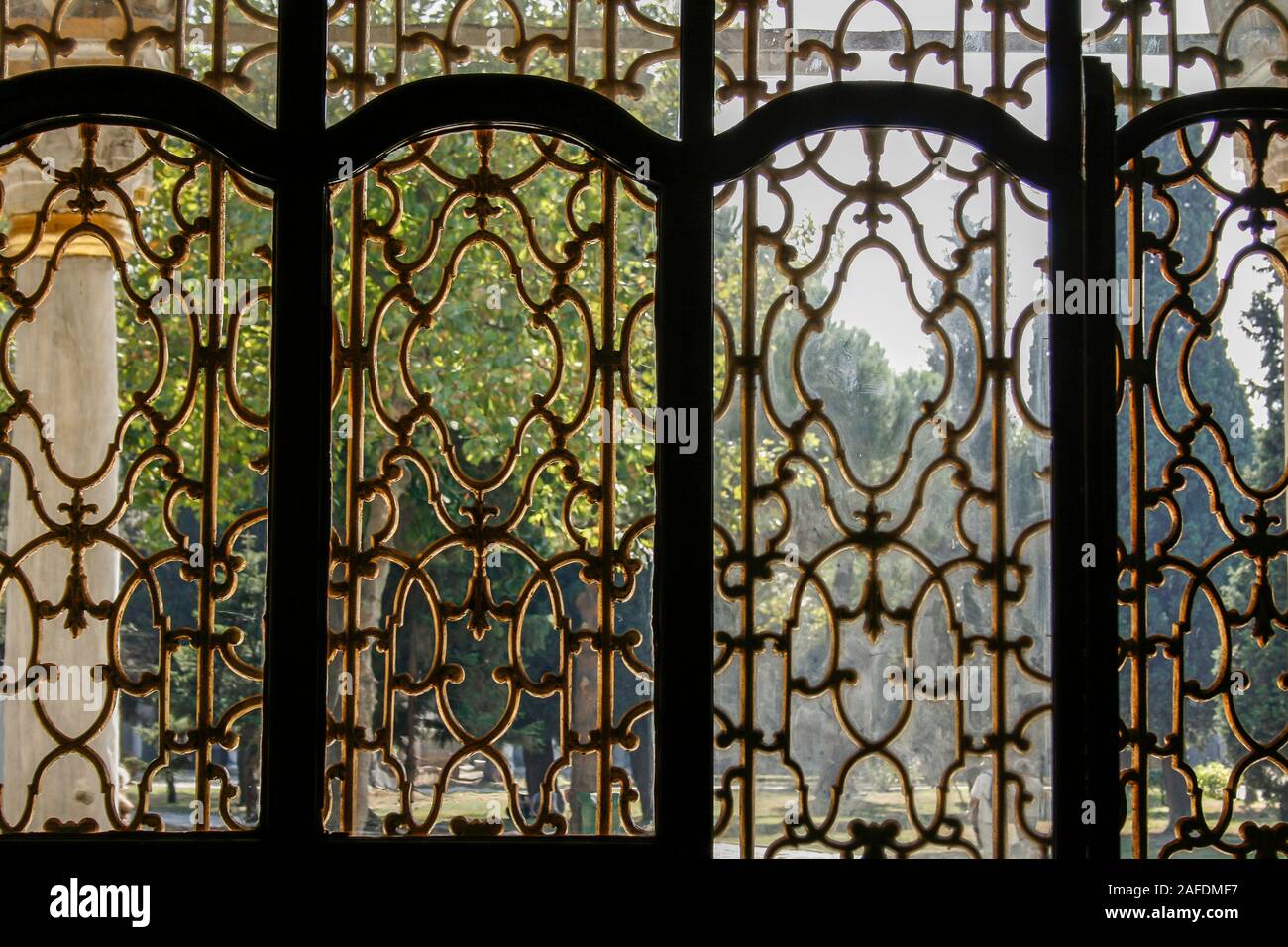 Looking through golden window frame at the harem of the Topkapi palace ...
