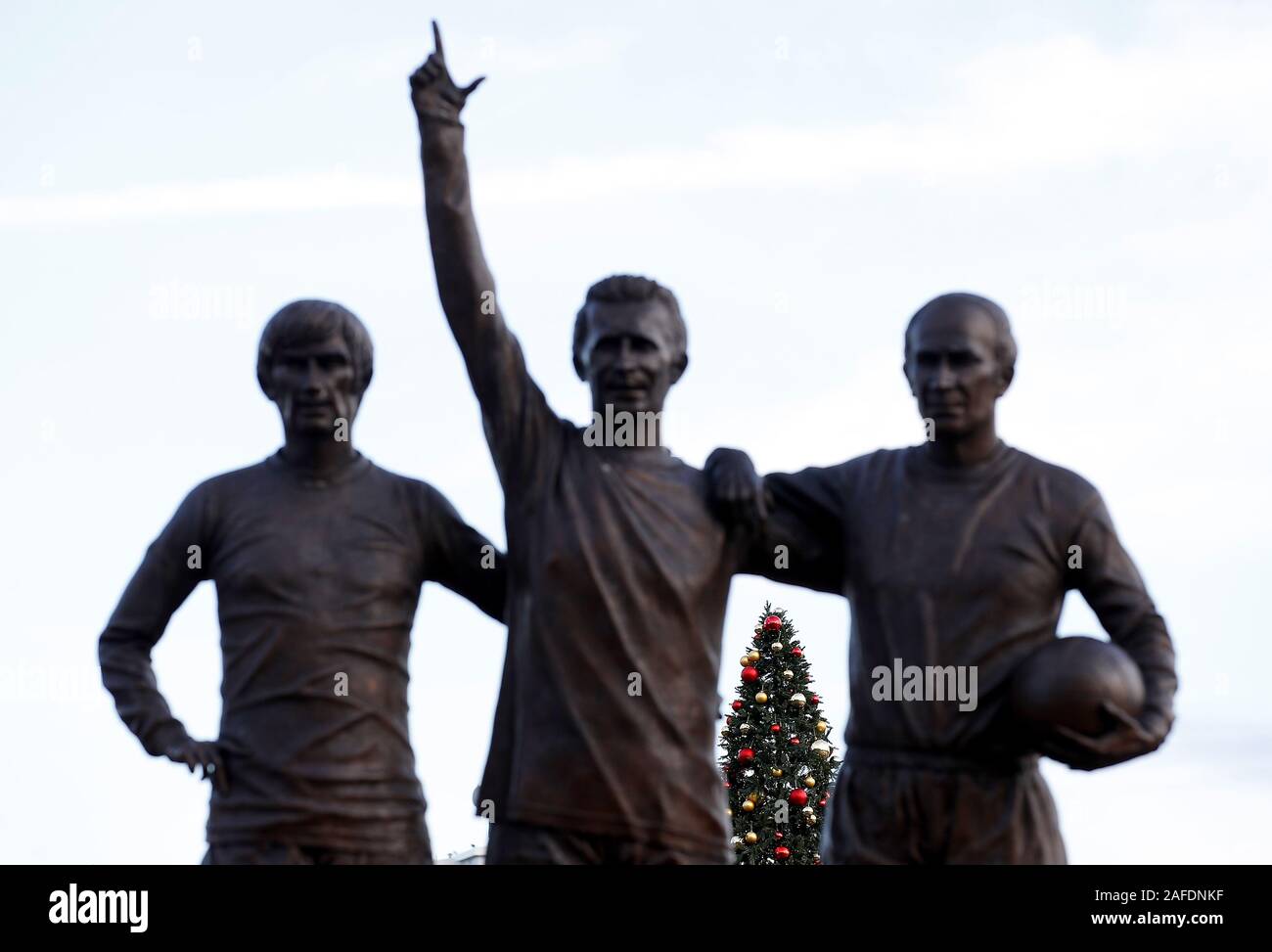 A view of the Christmas tree is seen behind the statue of Manchester ...