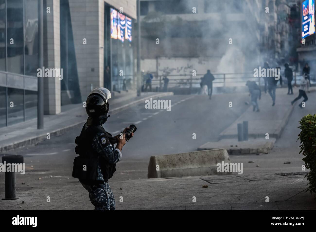 Beirut, Lebanon. 14th Dec, 2019. Security forces personel shoots tear ...