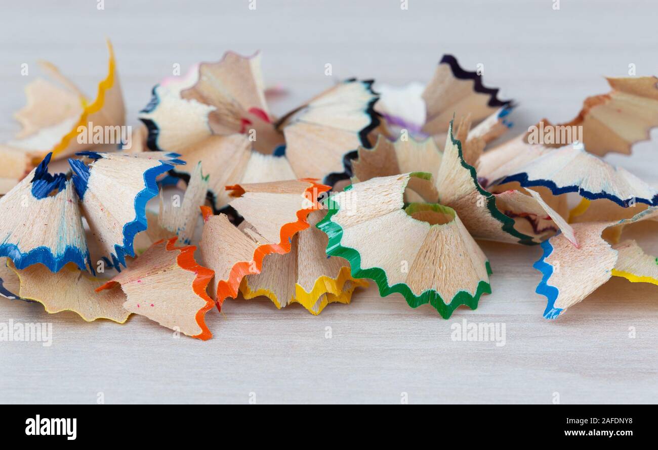 Shavings from sharpening colored pencils close-up on a light background ...